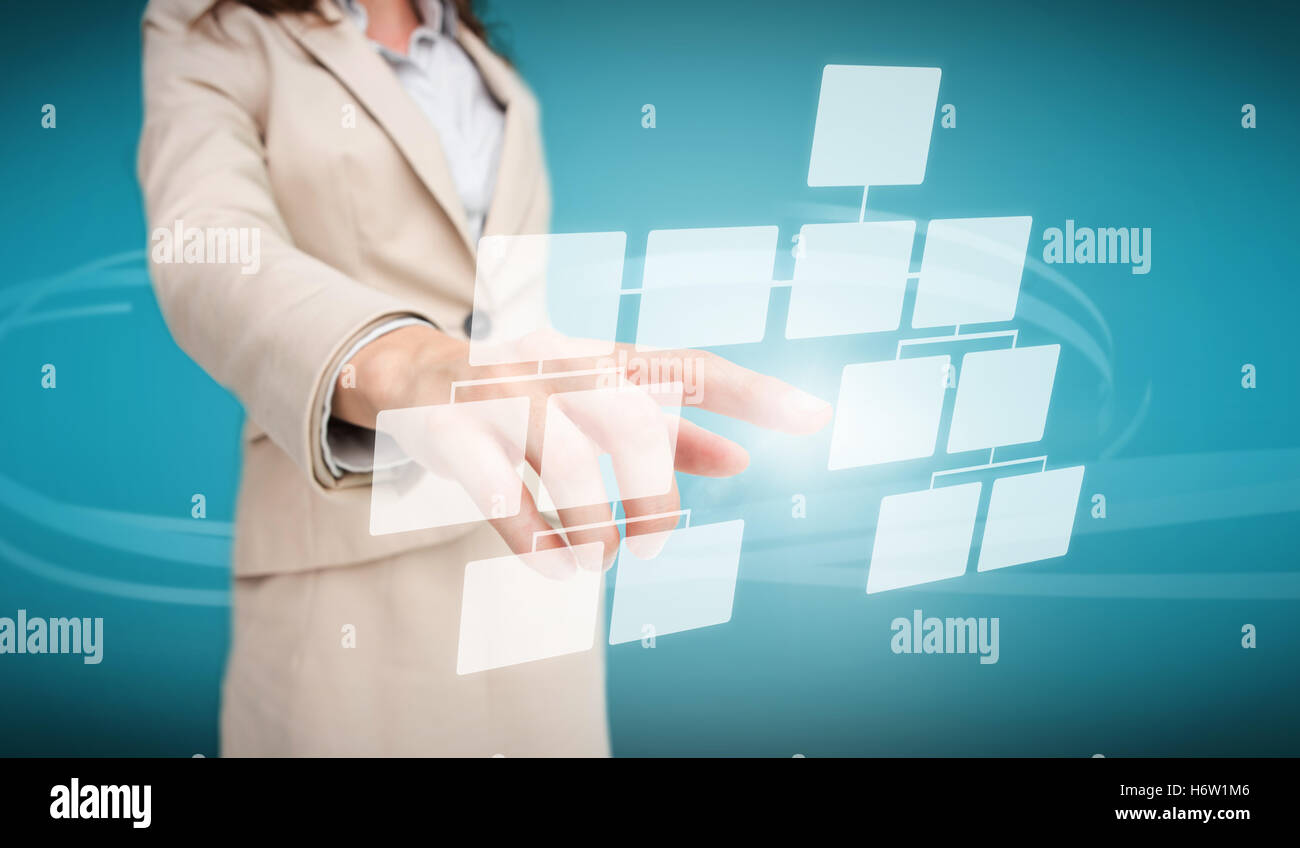 Businesswoman touching futuristic flow chart interface on blue ...