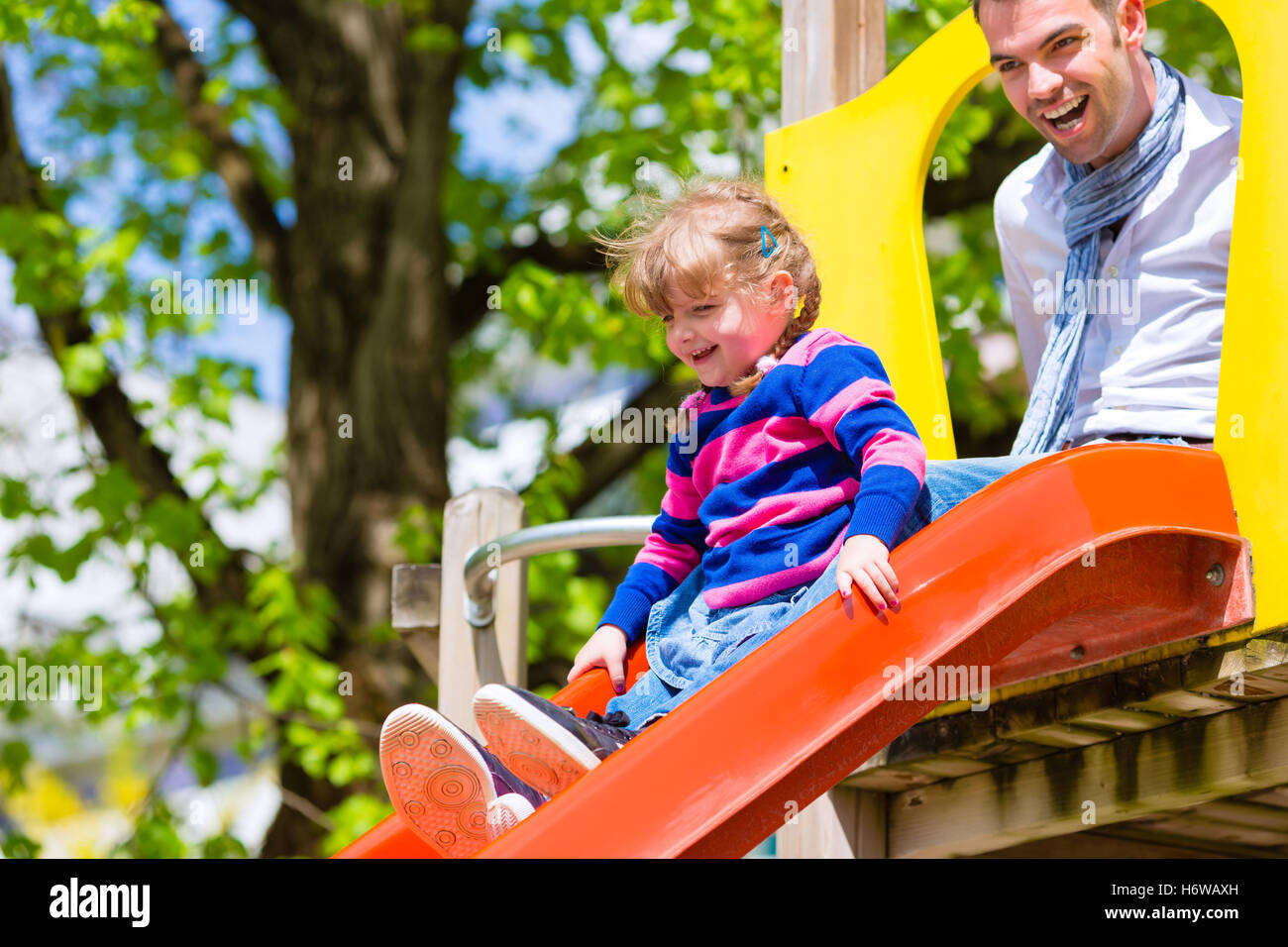 father and daughter on slide at playground Stock Photo - Alamy