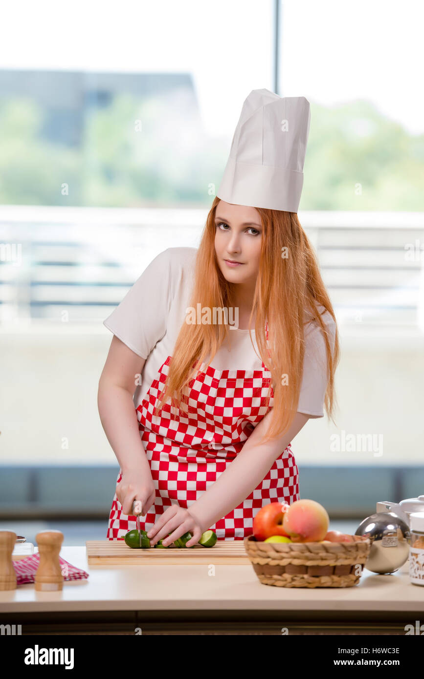 Redhead cook working in the kitchen Stock Photo - Alamy