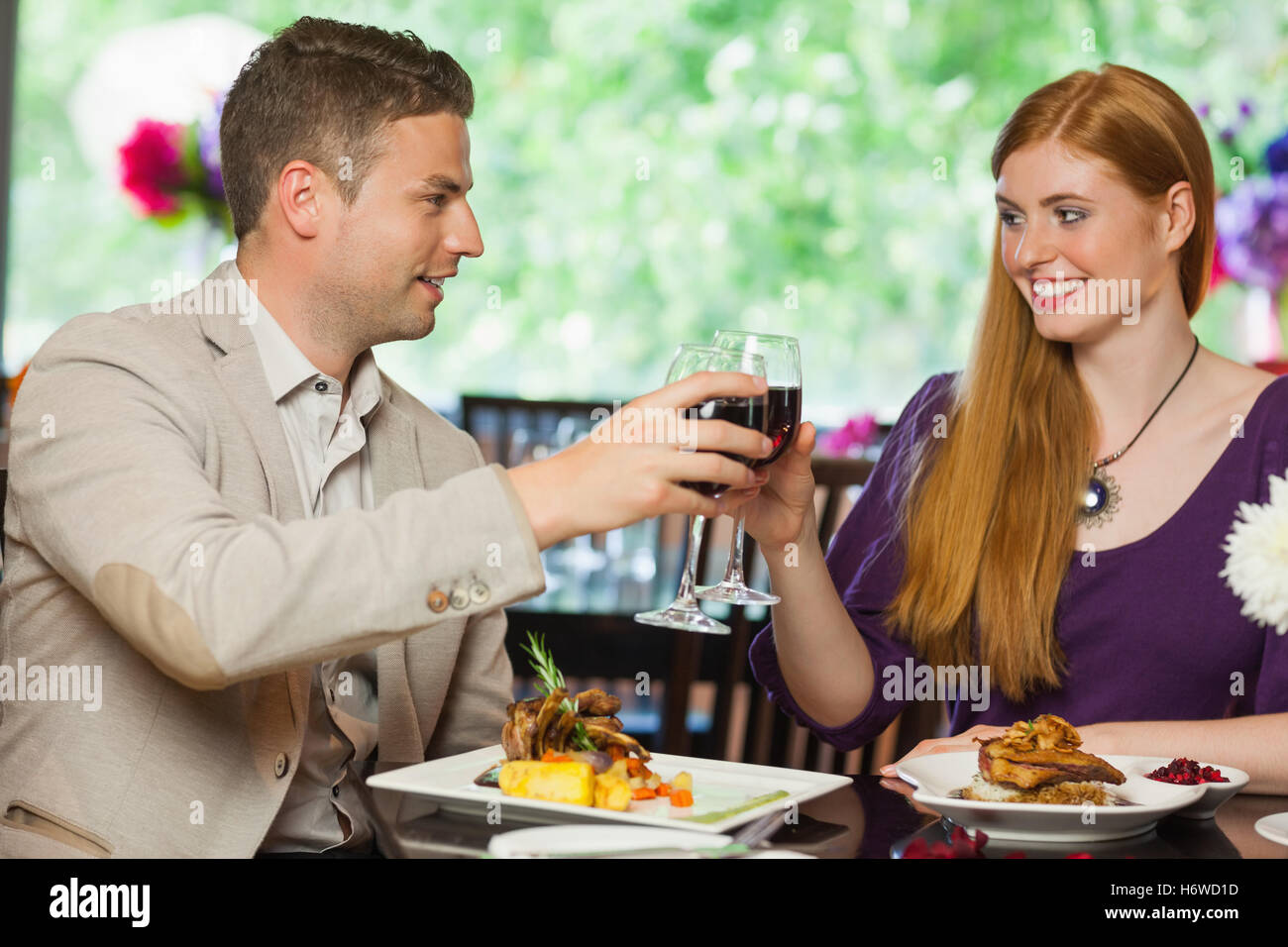 Cheerful couple having dinner together in a classy restaurant Stock Photo - Alamy