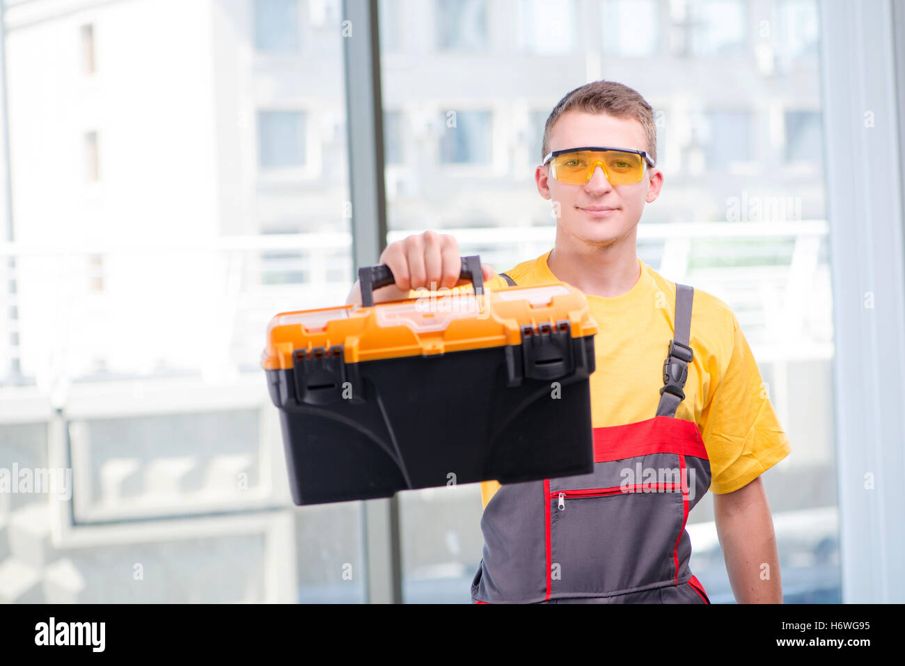 Young construction worker in yellow coveralls Stock Photo - Alamy