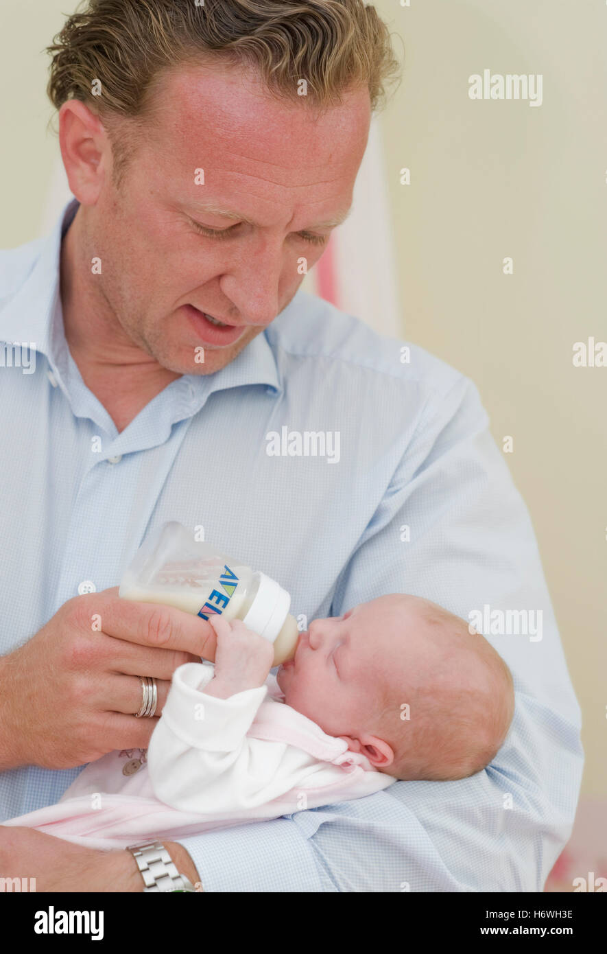 Father feeding baby with milk bottle Stock Photo - Alamy