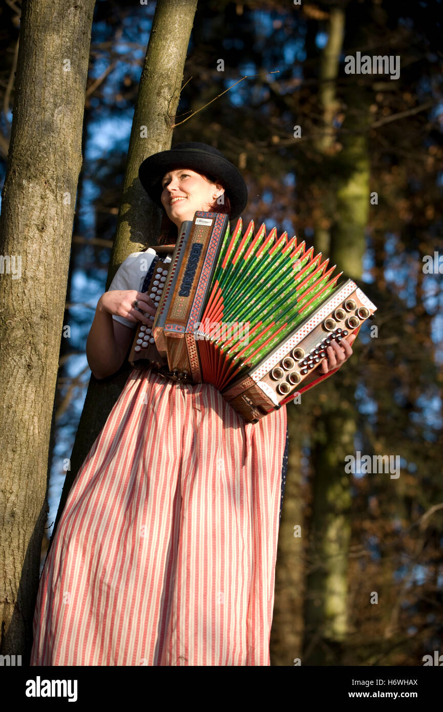 Woman in traditional costume with Styrian harmonica Stock Photo - Alamy