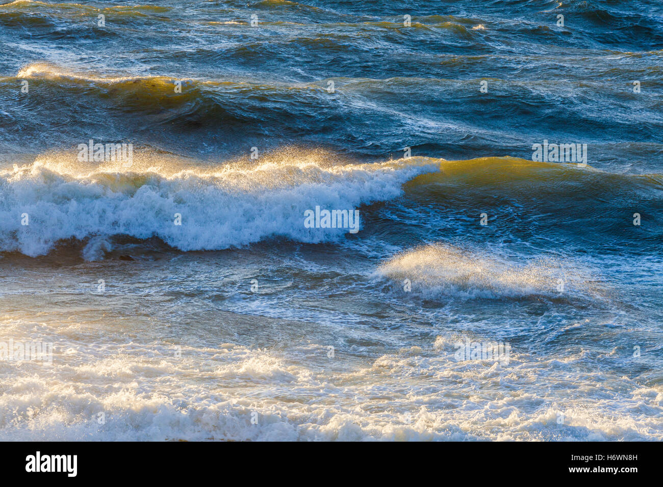 Big ocean waves glowing in sunset Stock Photo - Alamy