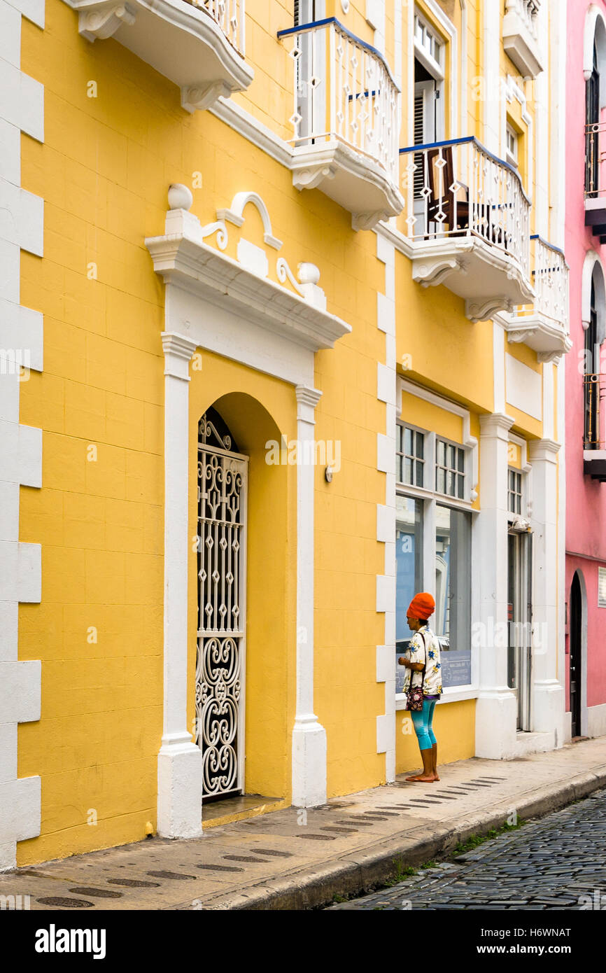 Lady in red head dress walking on Calle De La Cruz, Old San Juan ...