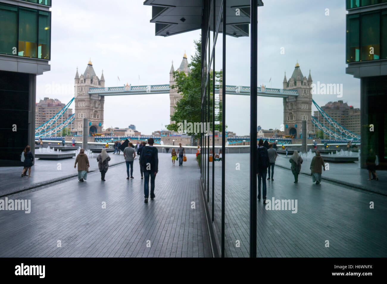 Tower Bridge London mirroring in the glass buildings of More London ...