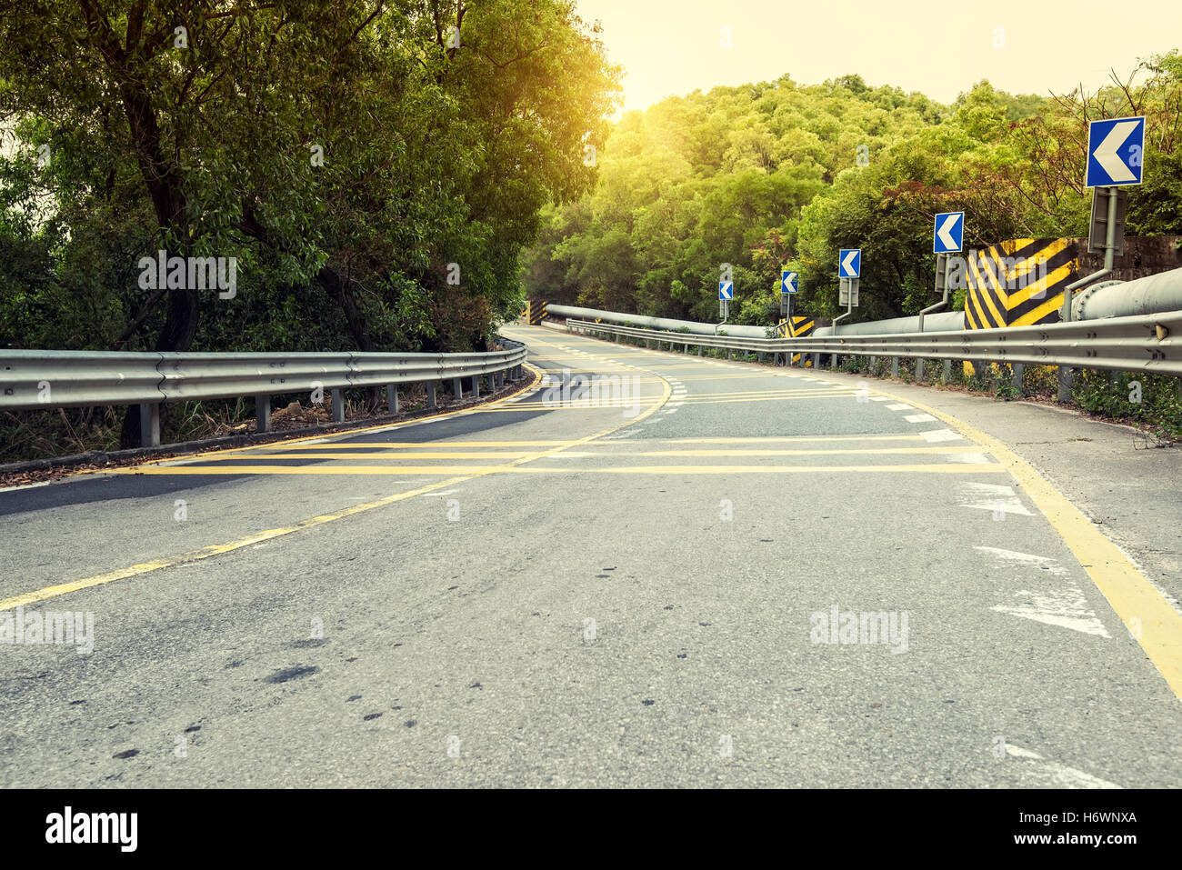 Empty curved road Stock Photo - Alamy