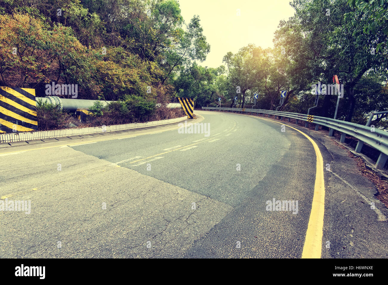 Empty curved road Stock Photo - Alamy