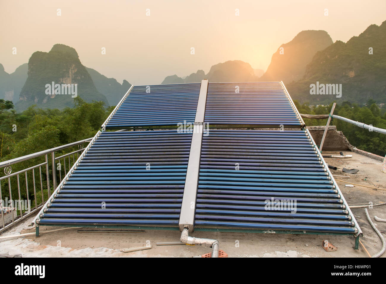 Solar water heating panel on a house roof Stock Photo - Alamy