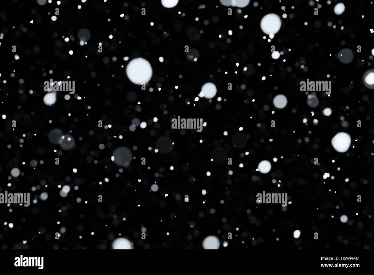 Falling snow on black background Stock Photo - Alamy