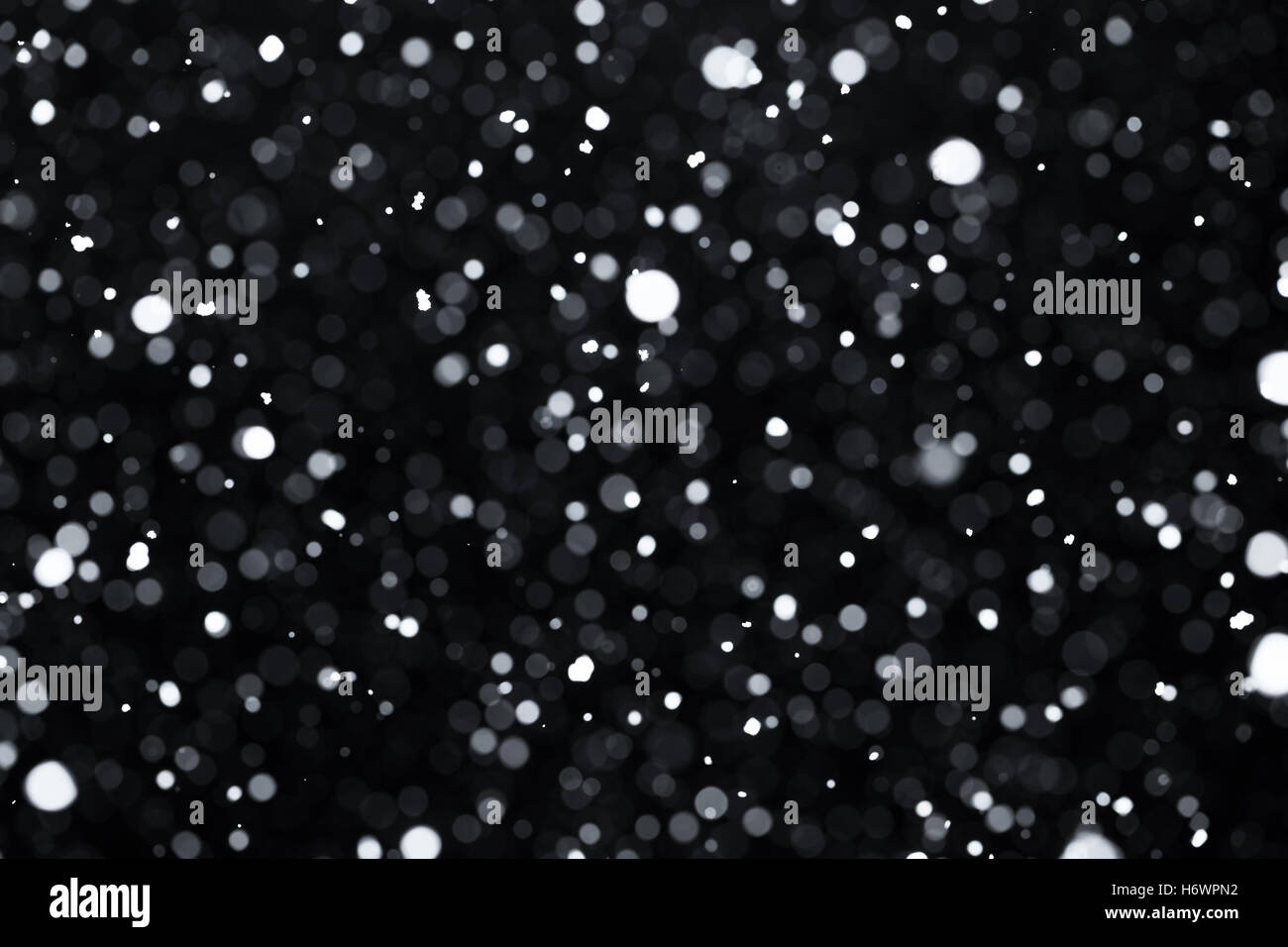 Falling snow on black background Stock Photo - Alamy