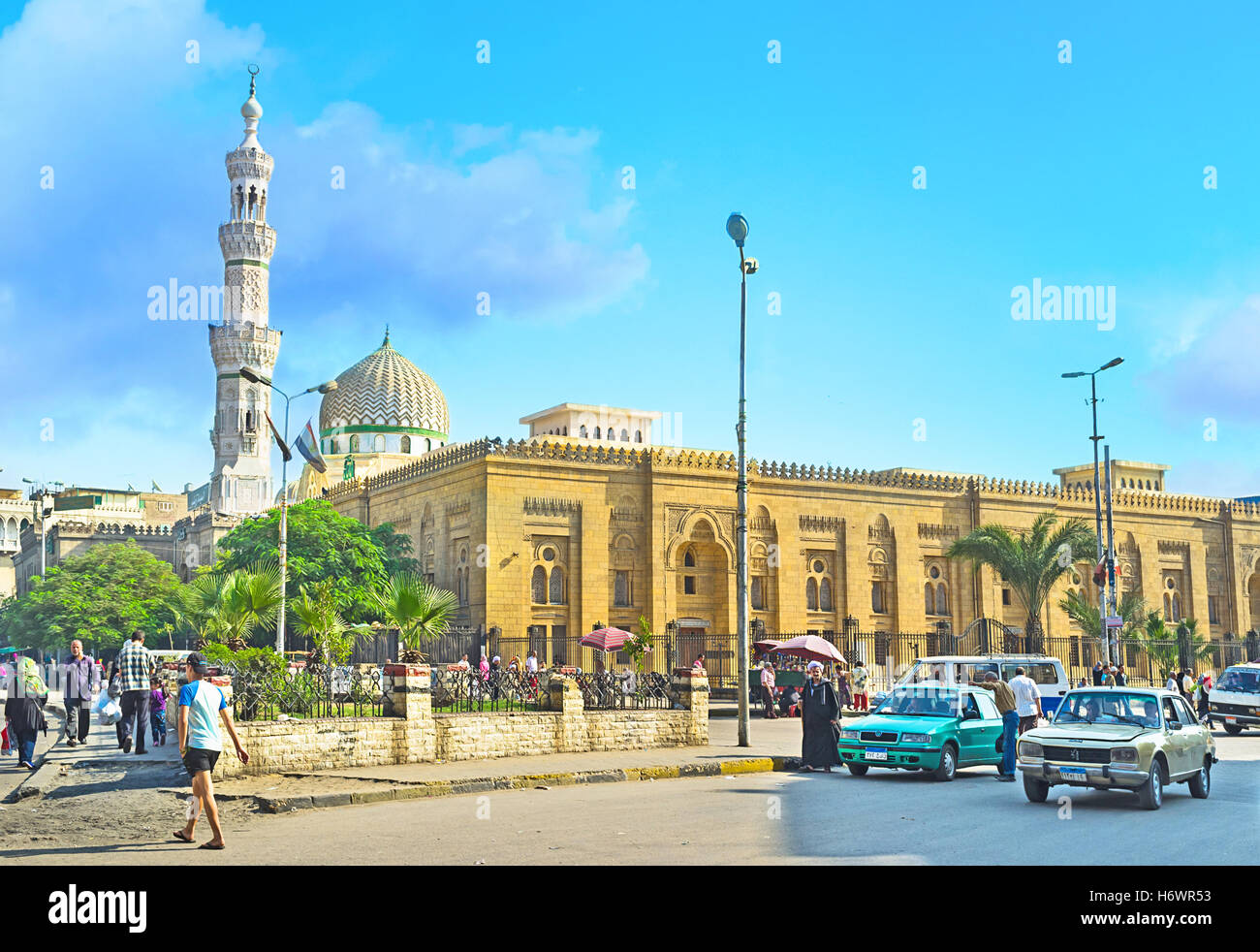 The busy street of Port Said with the white minaret of Al Sayyeda ...