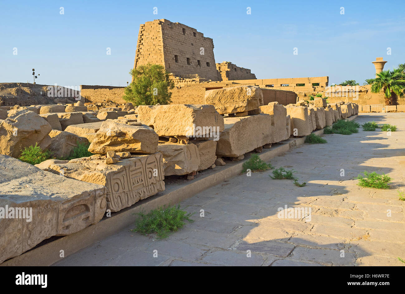 The ancient wall of the First Pylon rises over the ruins of Karnak ...