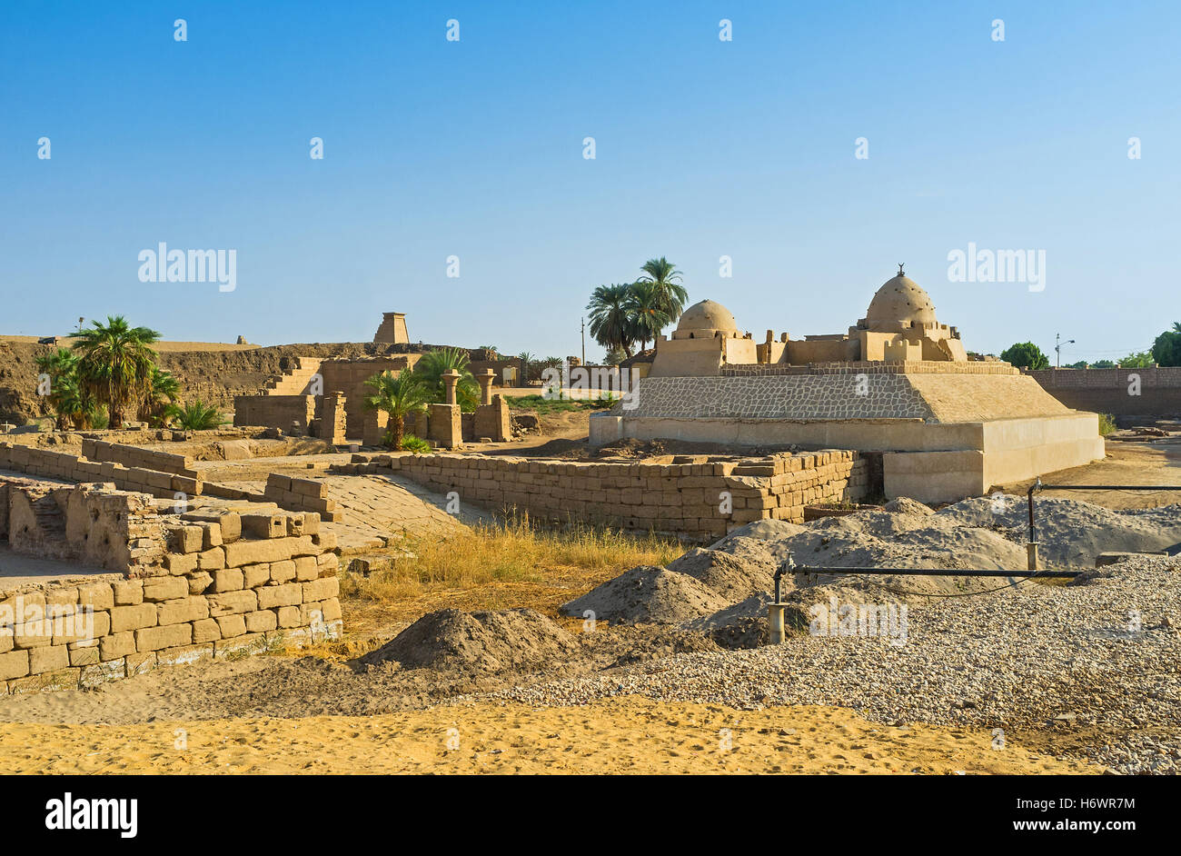 The old clay mosque among the ancient ruins, located in front of the ...