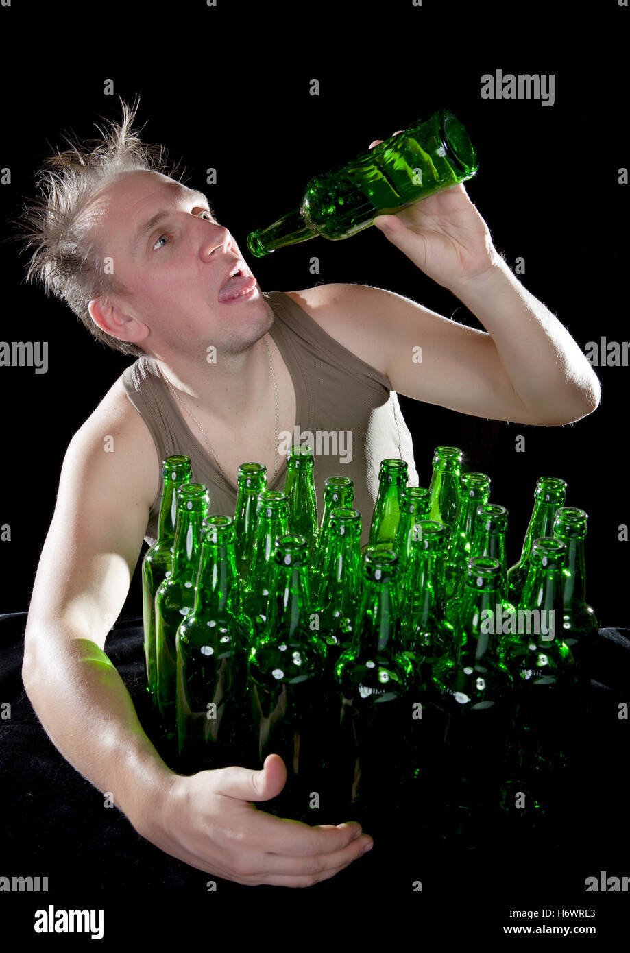 The happy tipsy man near empty beer bottles Stock Photo - Alamy