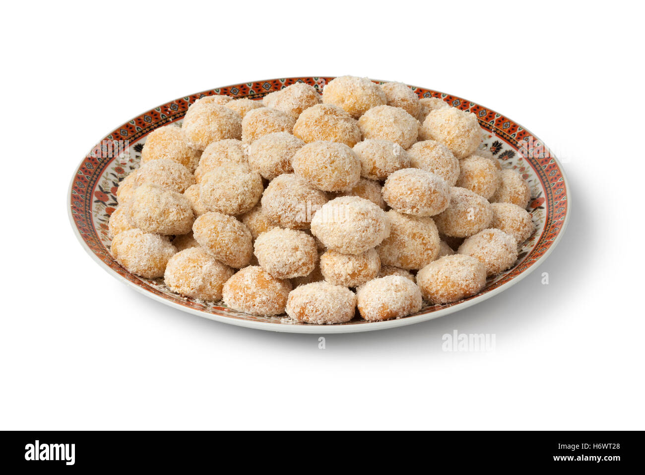 Dish with traditional Moroccan coconut cookies on white background ...
