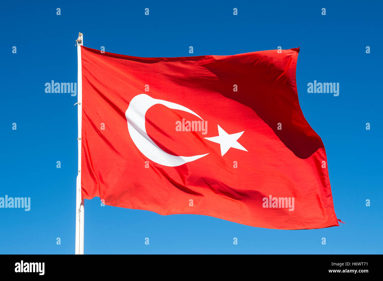 Turkish flag waving in bright blue sky Stock Photo - Alamy
