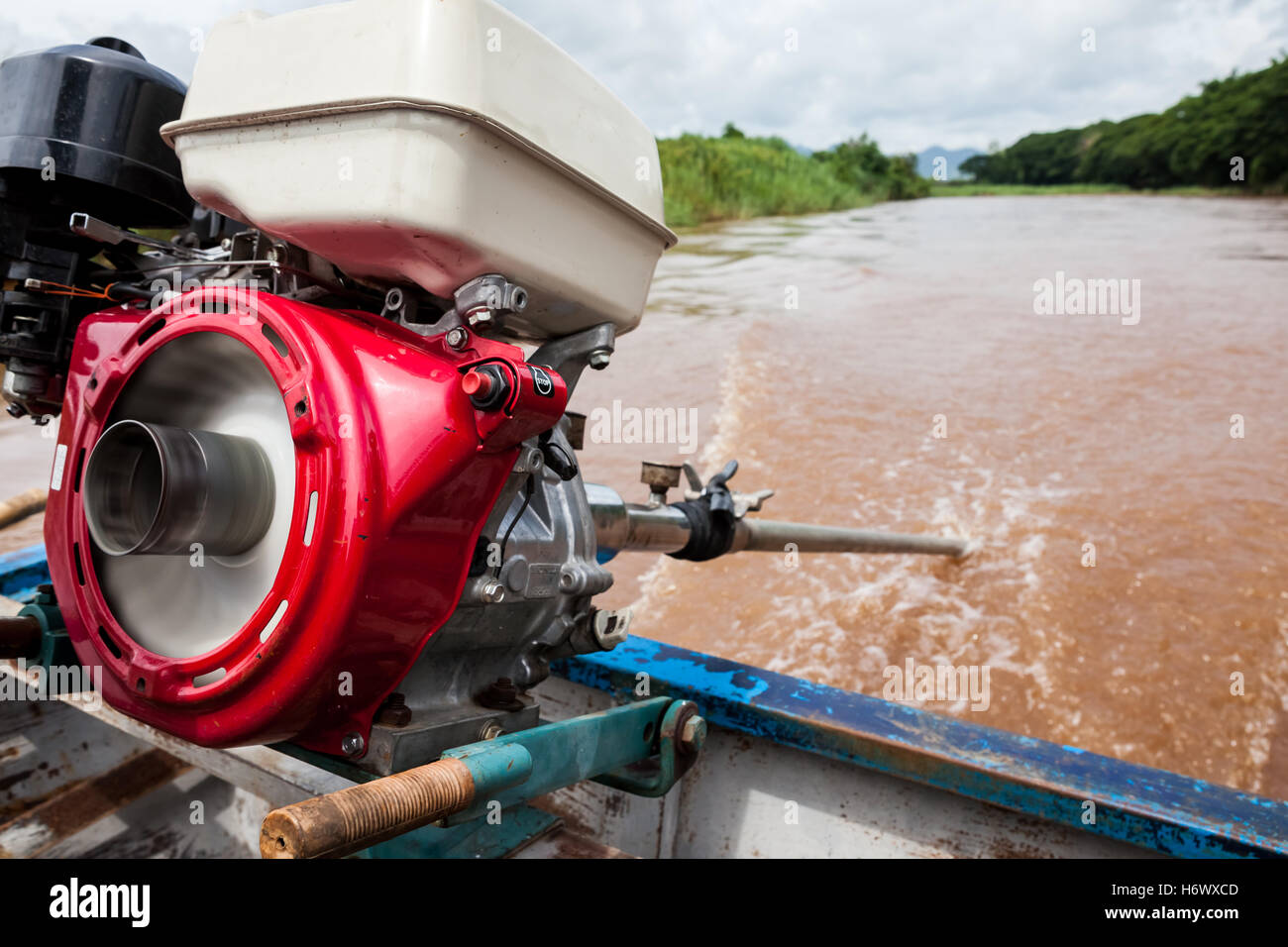 on the river in Thailand running a motor of a boat Stock Photo - Alamy