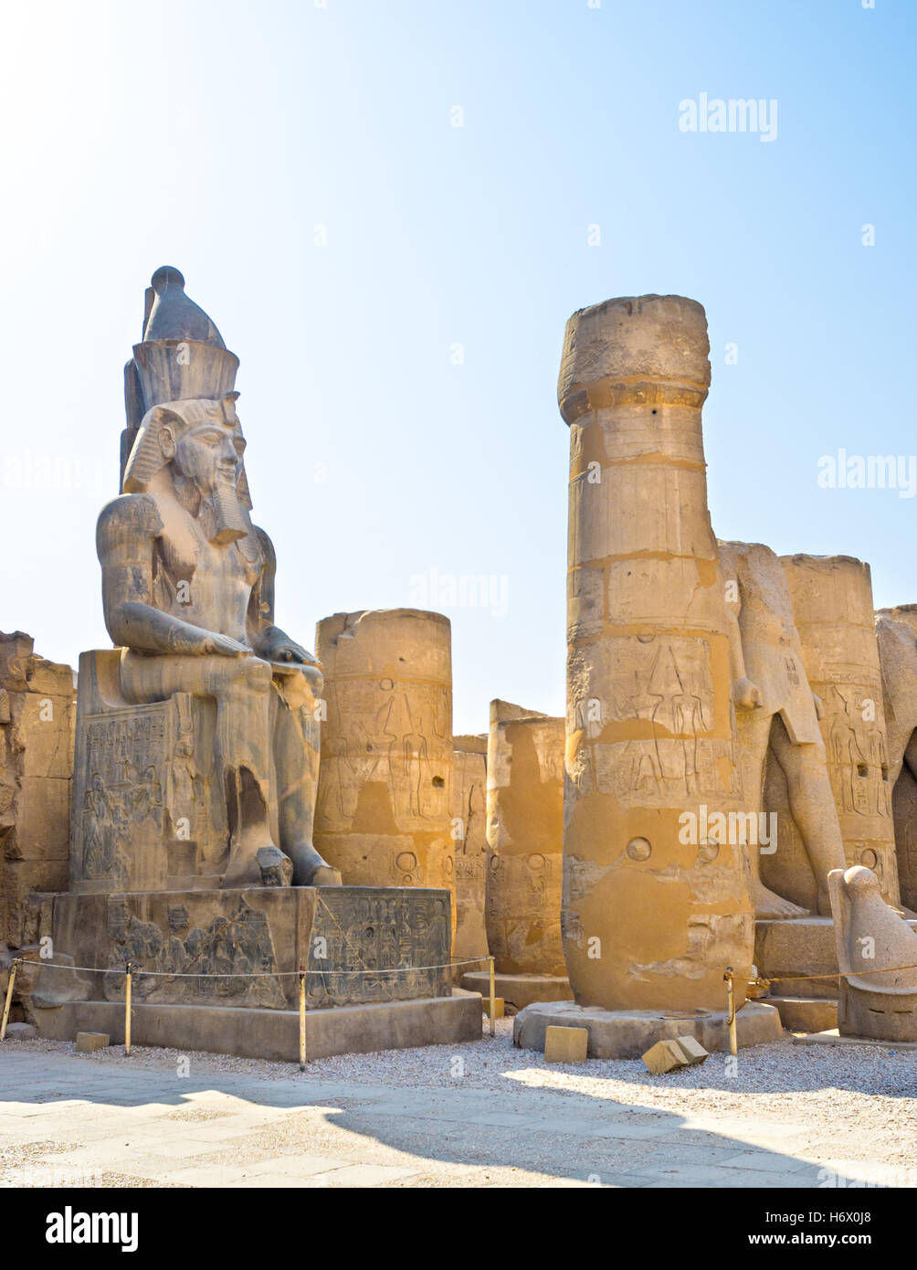 The colossus of Ramesses II, sitting among the ruins of the ancient ...
