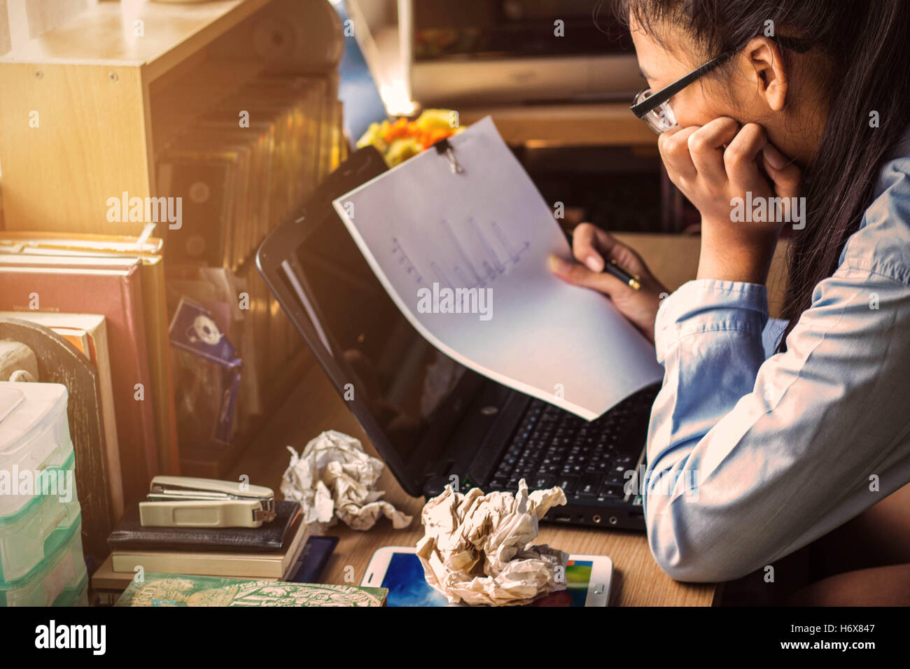 Girls who are stressed with work on the desk at office Stock Photo - Alamy