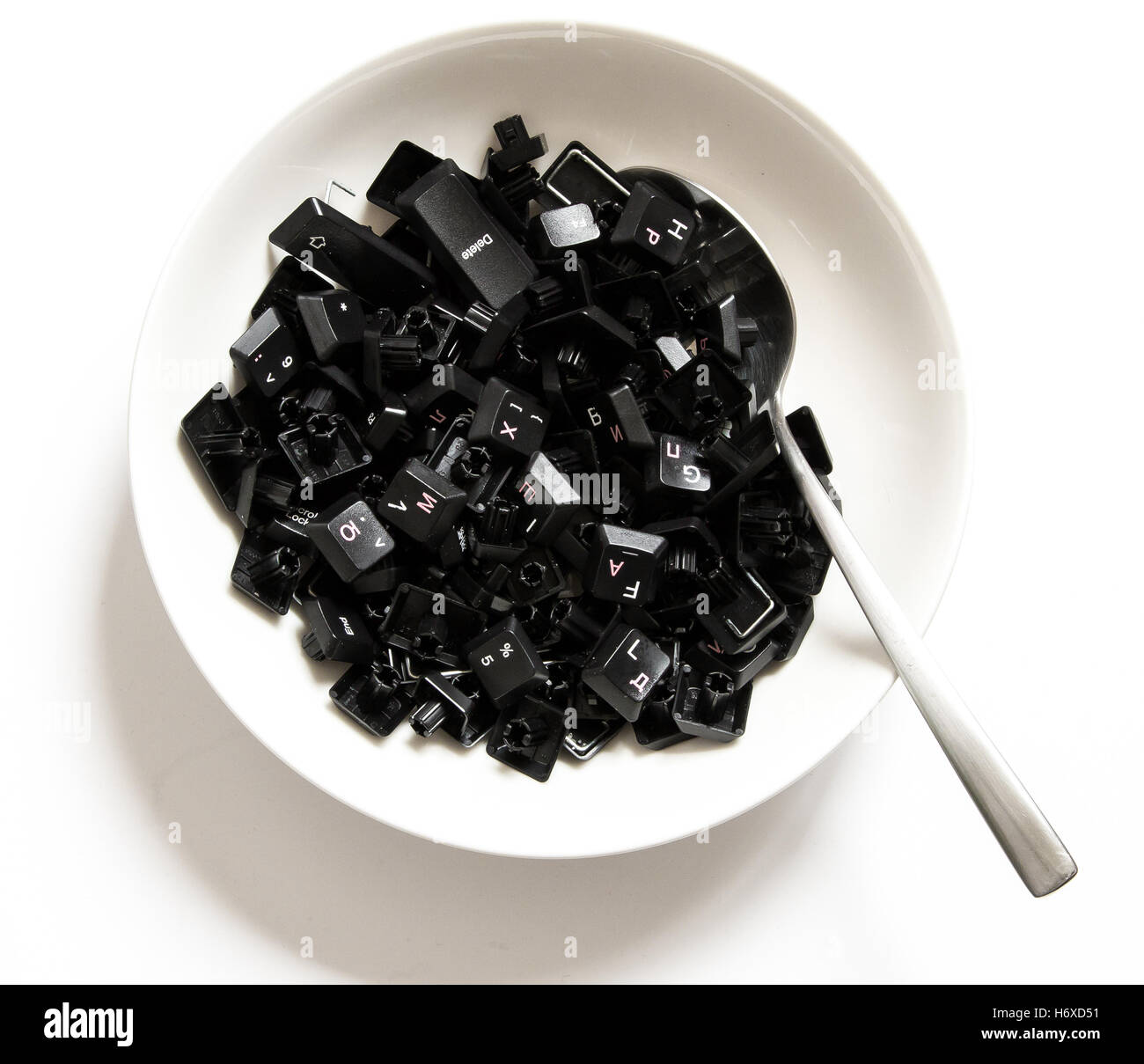 Keyboard keys in a dish with a spoon Stock Photo - Alamy