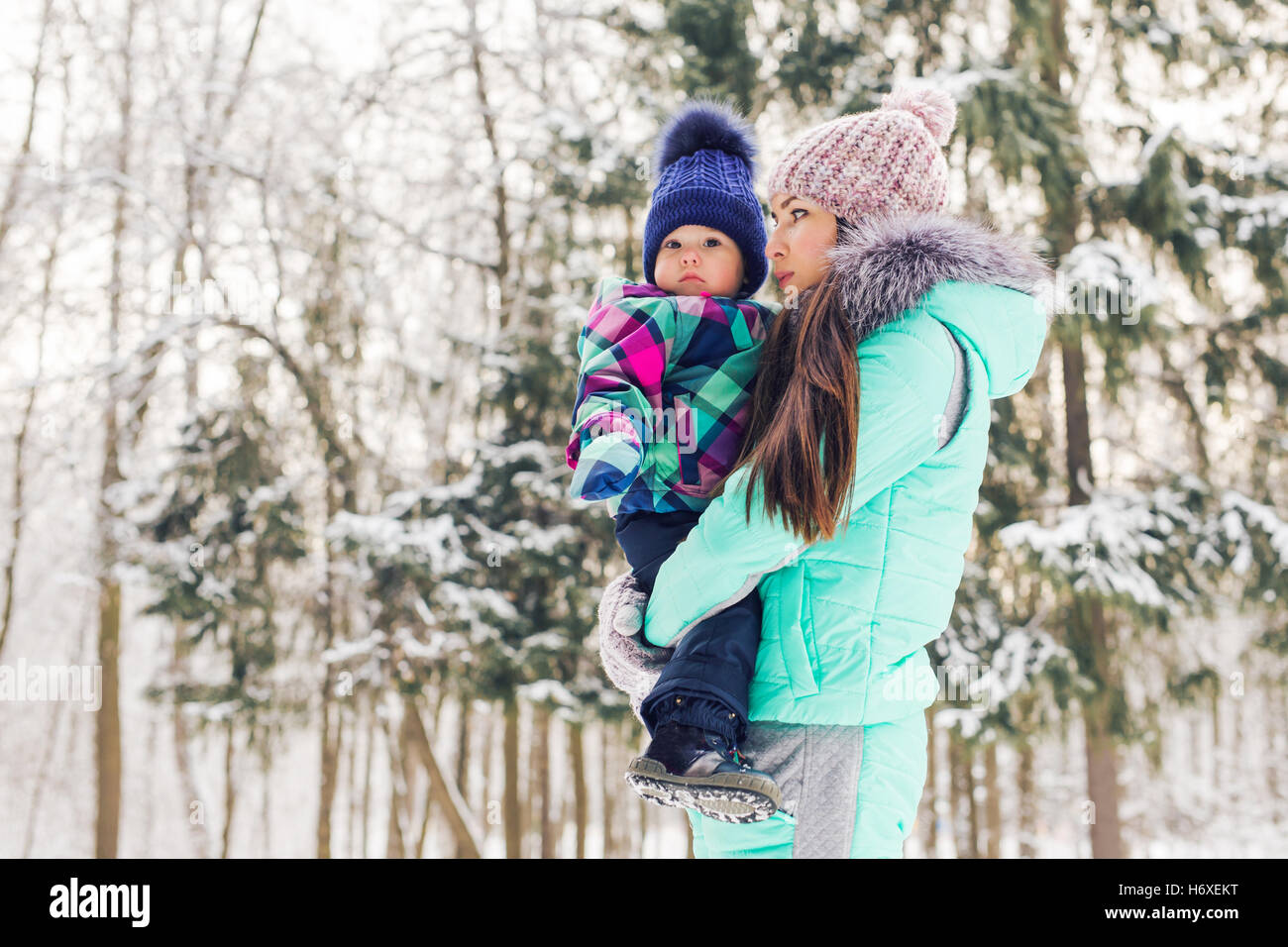 happy family mother and child baby daughter on a winter walk in the ...