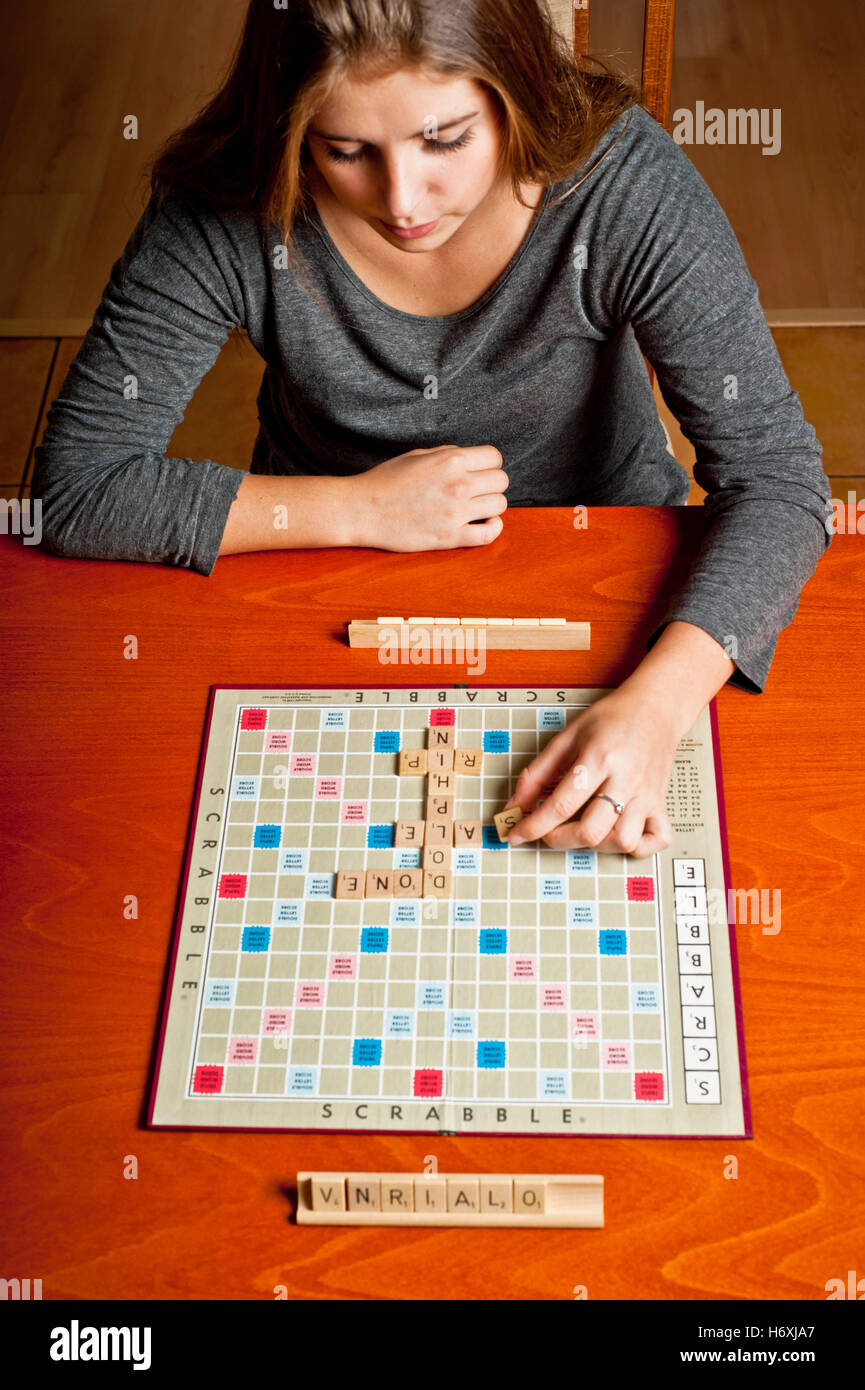 young brunette teenager girl playing scrabble Stock Photo - Alamy