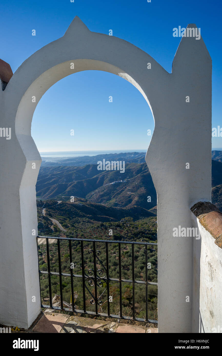 Andalucian landscape seen through arch of Castillo de Comares. Comarca ...