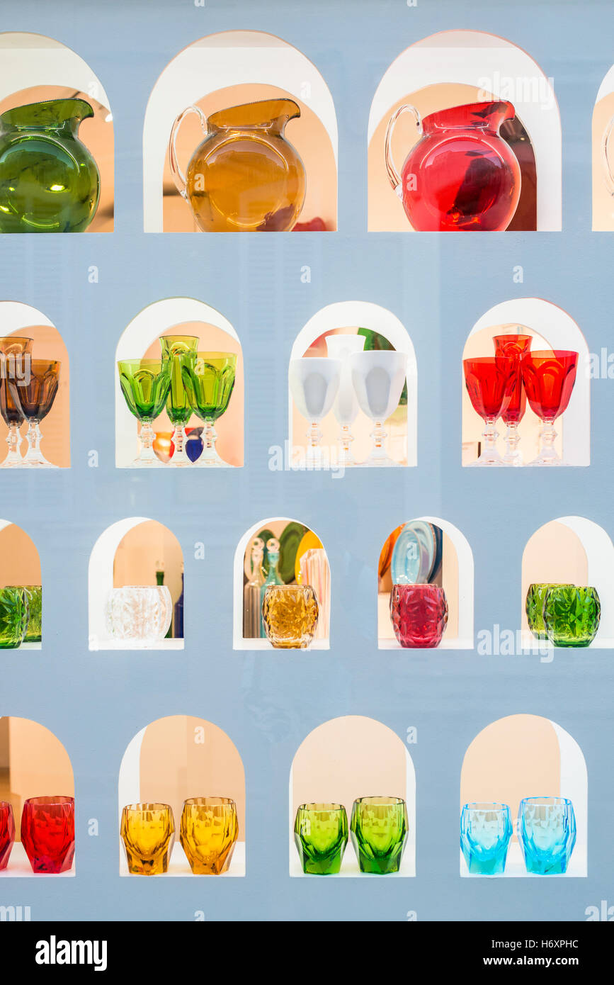 Colored glass cups on showcase Stock Photo - Alamy