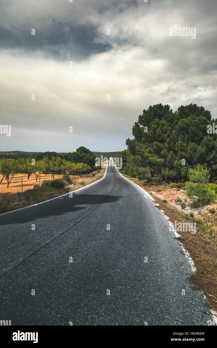 Road in the mountain. Dramatic scene Stock Photo - Alamy