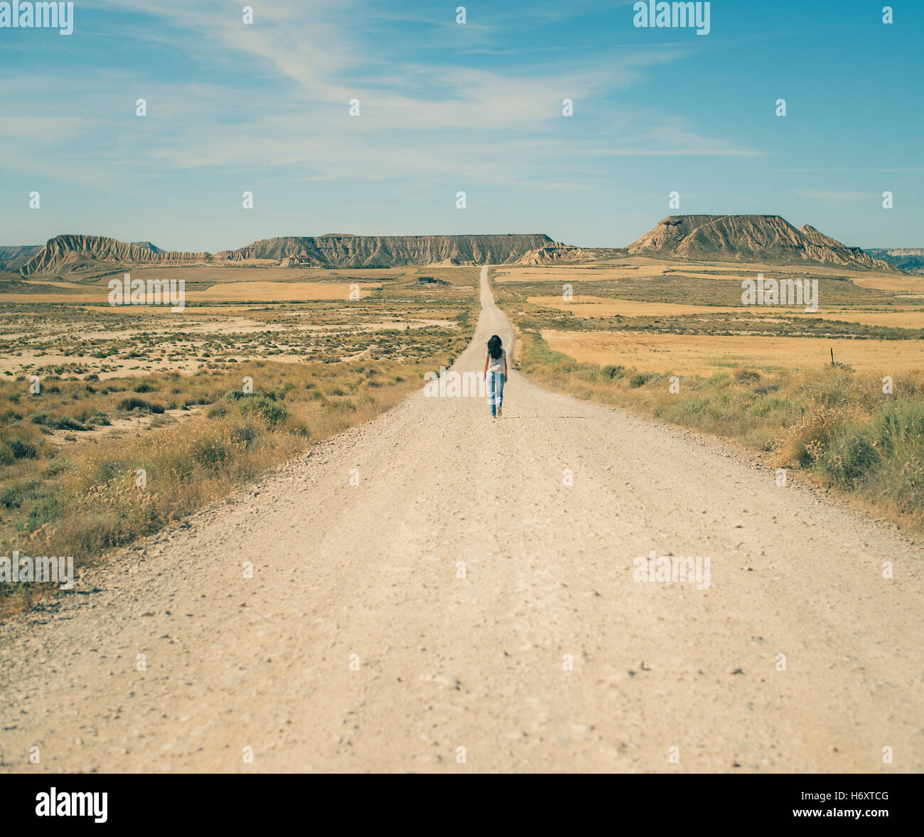 Woman walking on dirt road. Looking like a movie Stock Photo - Alamy