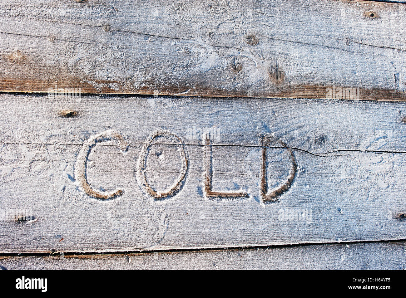 Cold written on a wooden background with frosts Stock Photo - Alamy