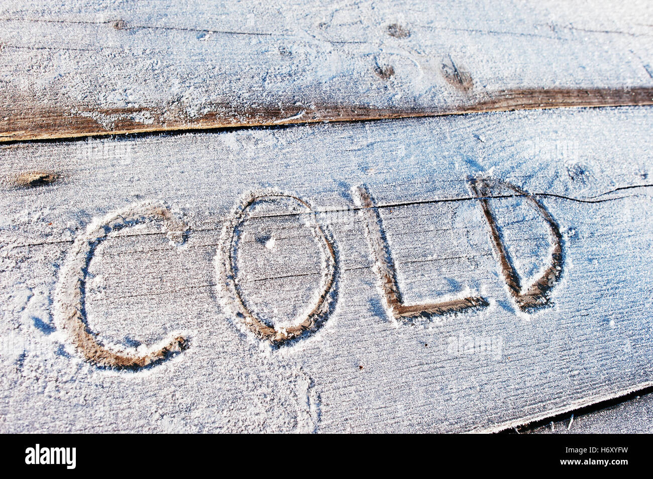 Cold written on a wooden background with frosts Stock Photo - Alamy