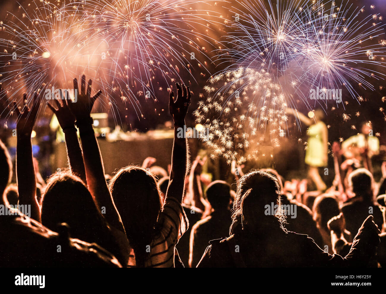 New Year concept - cheering crowd and fireworks Stock Photo - Alamy