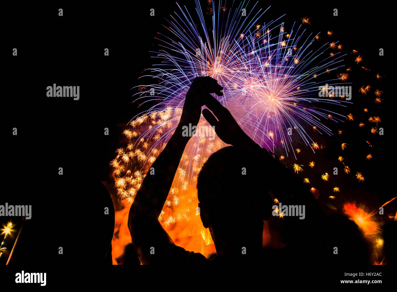New Year concept - cheering crowd and fireworks Stock Photo - Alamy