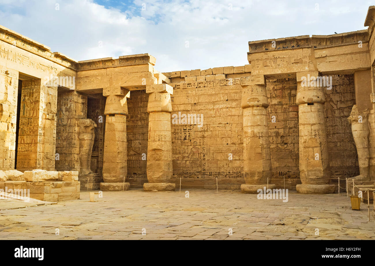 The ruined peristyle court with preserved hieroglyphs and reliefs on ...
