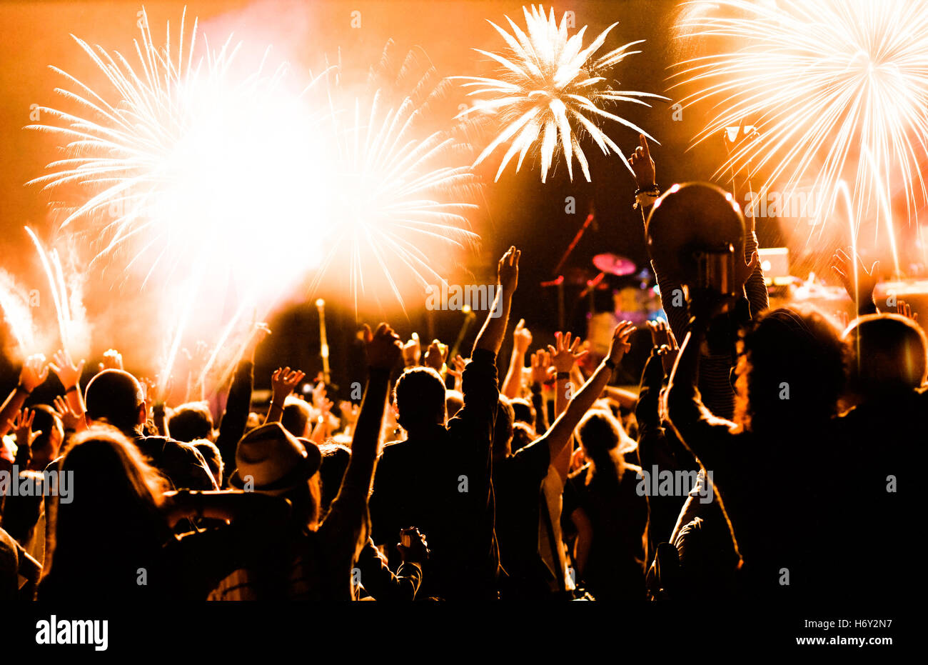 New Year concept - cheering crowd and fireworks Stock Photo - Alamy