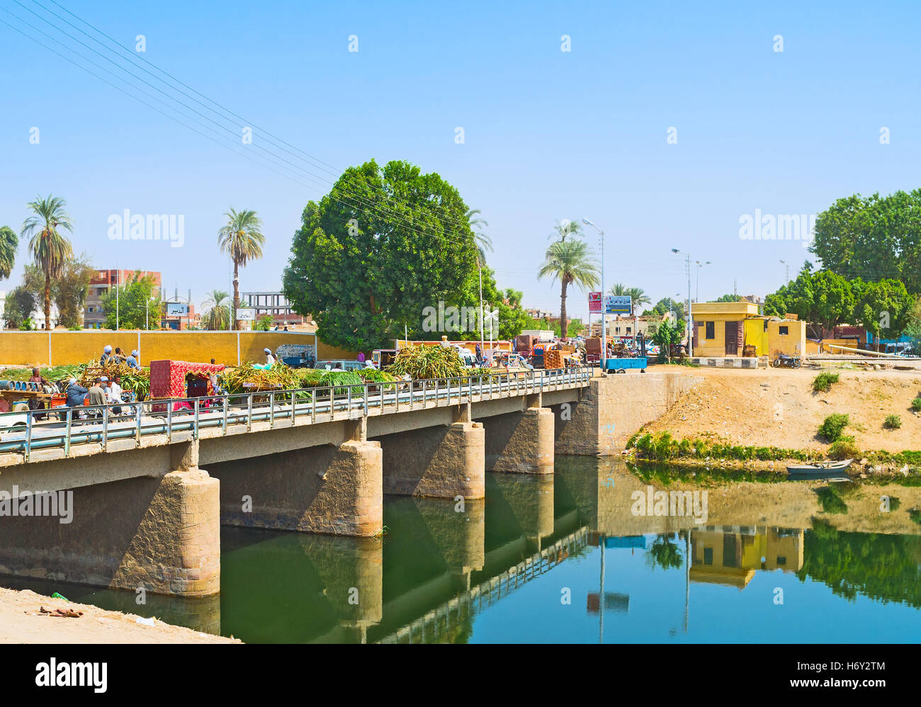 The numerous donkey carts in traffic jam on the narrow bridge, Esna ...
