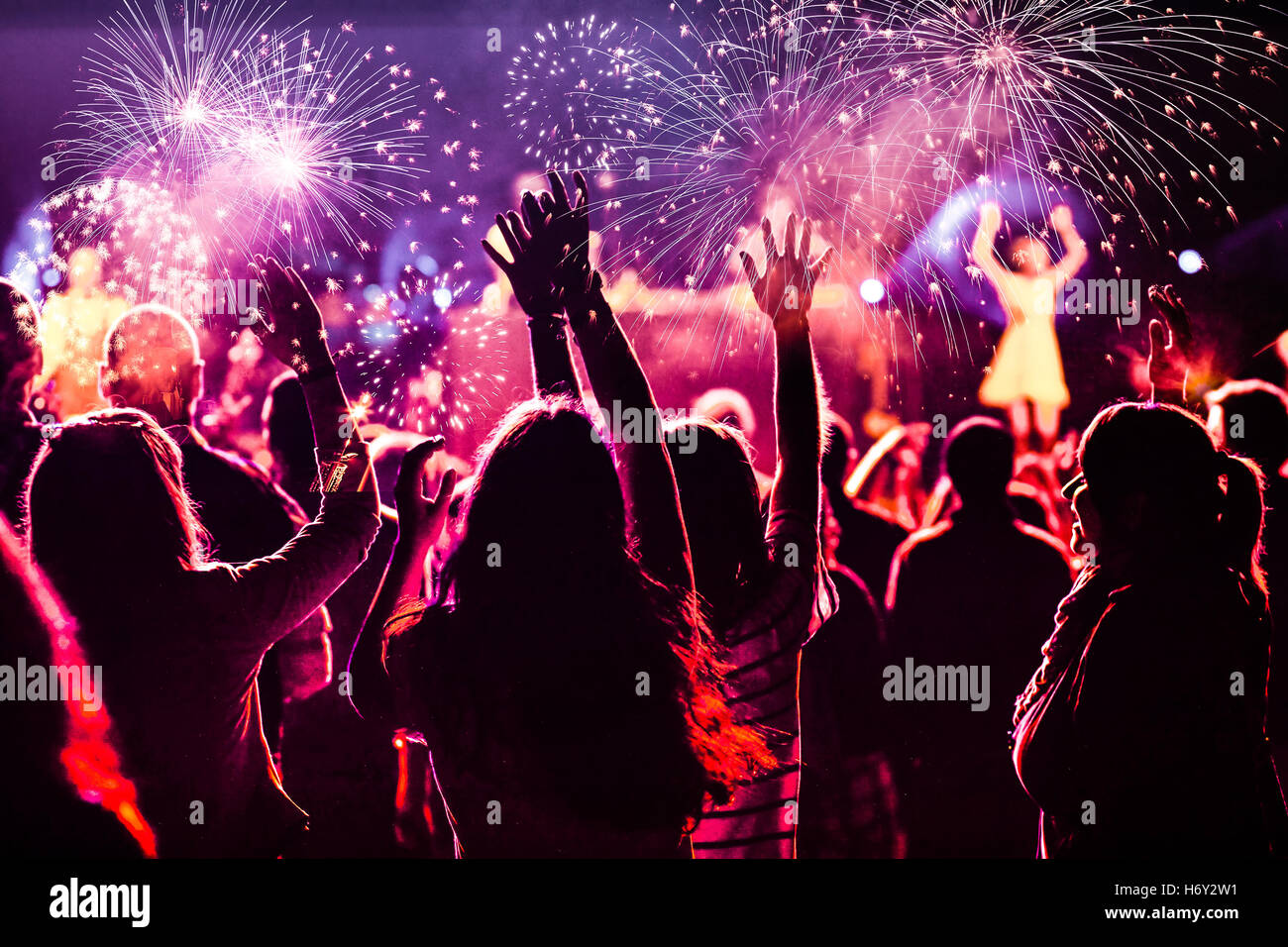 New Year concept - cheering crowd and fireworks Stock Photo - Alamy
