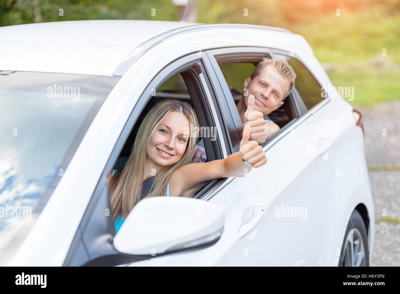Young happy people enjoying a roadtrip in the car Stock Photo - Alamy
