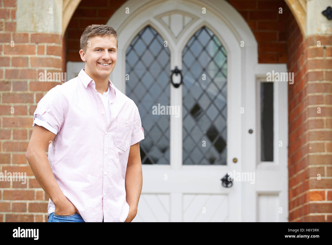 Portrait Of Man Standing Outside Front Door Of Home Stock Photo - Alamy