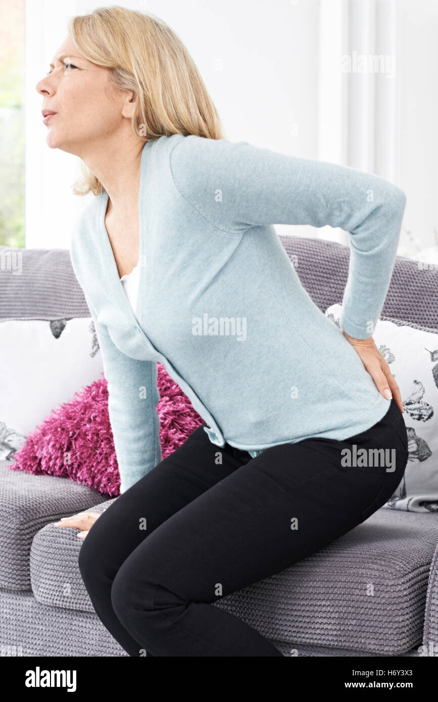 Backache woman sofa hi-res stock photography and images - Alamy