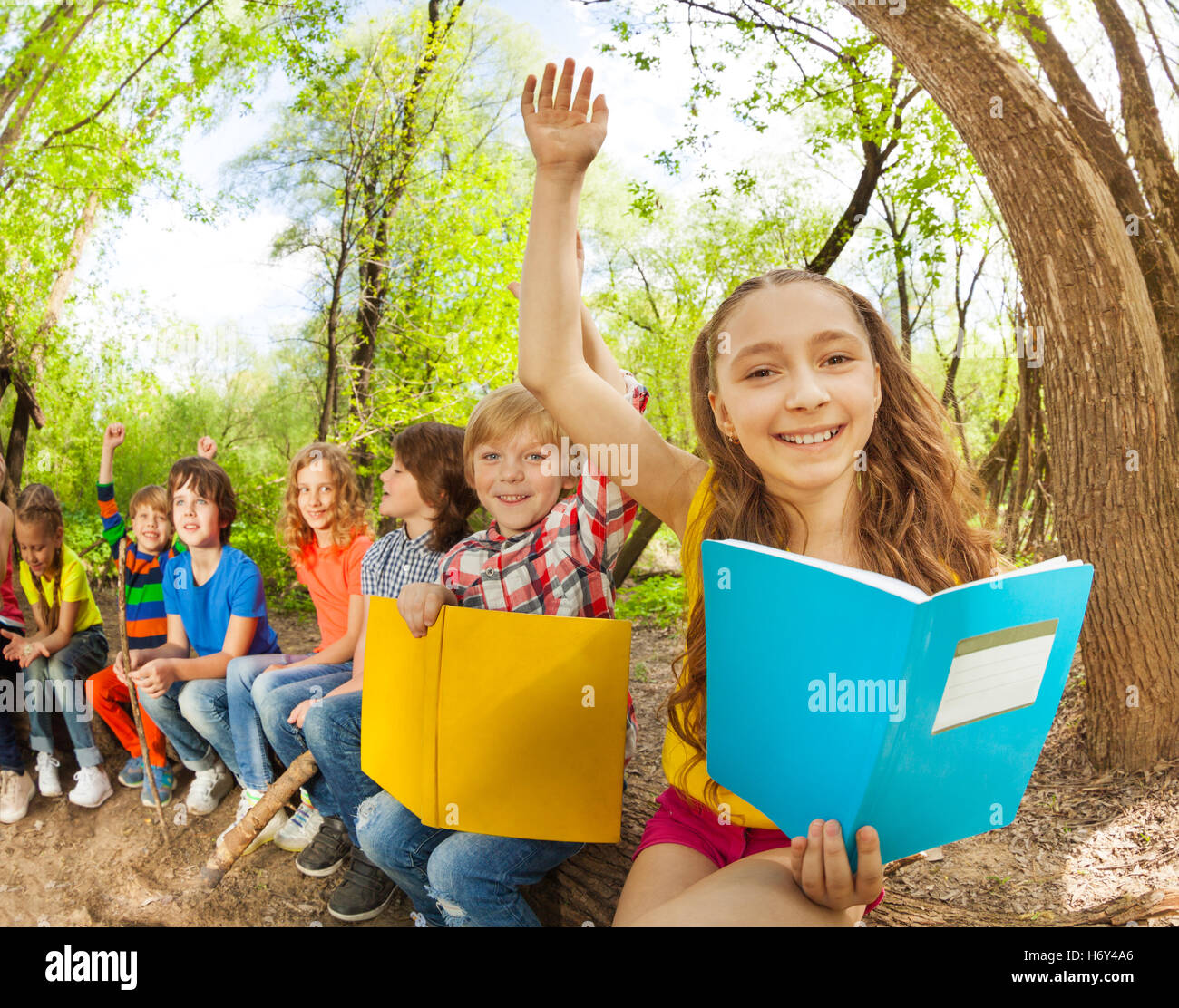 Happy kids reading books outdoor at sunny day Stock Photo - Alamy