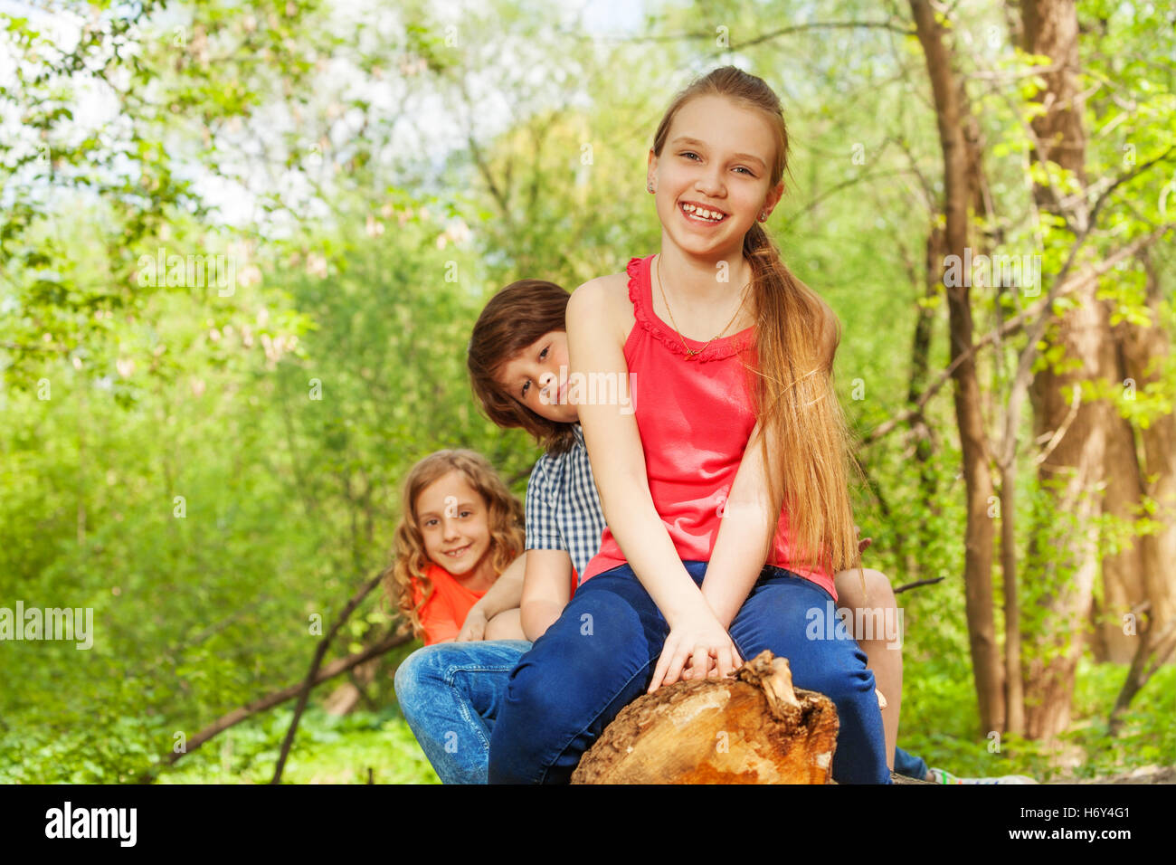 Boy sitting on log in forest hi-res stock photography and images - Alamy
