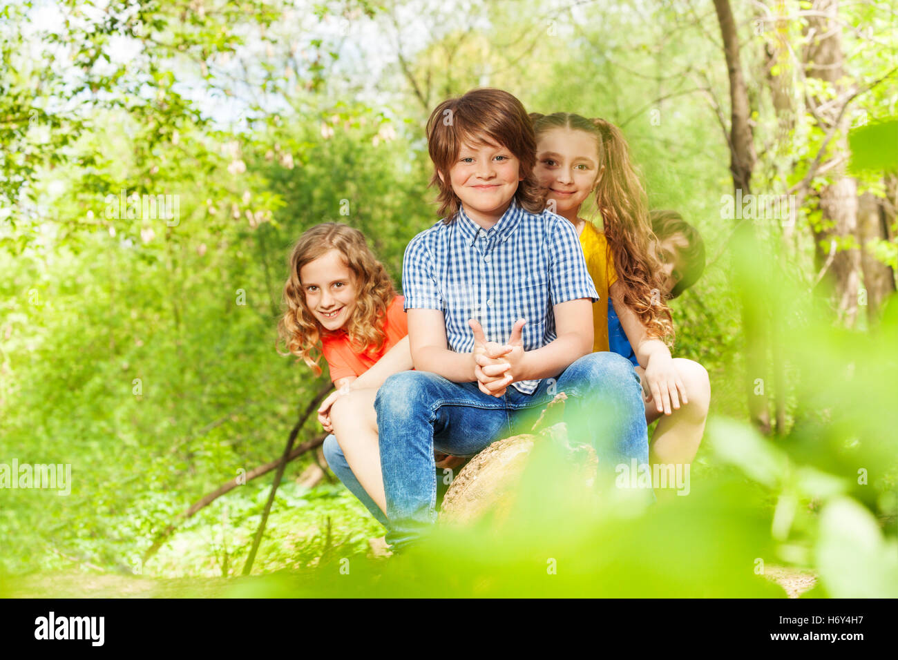 Boy sitting on log in forest hi-res stock photography and images - Alamy