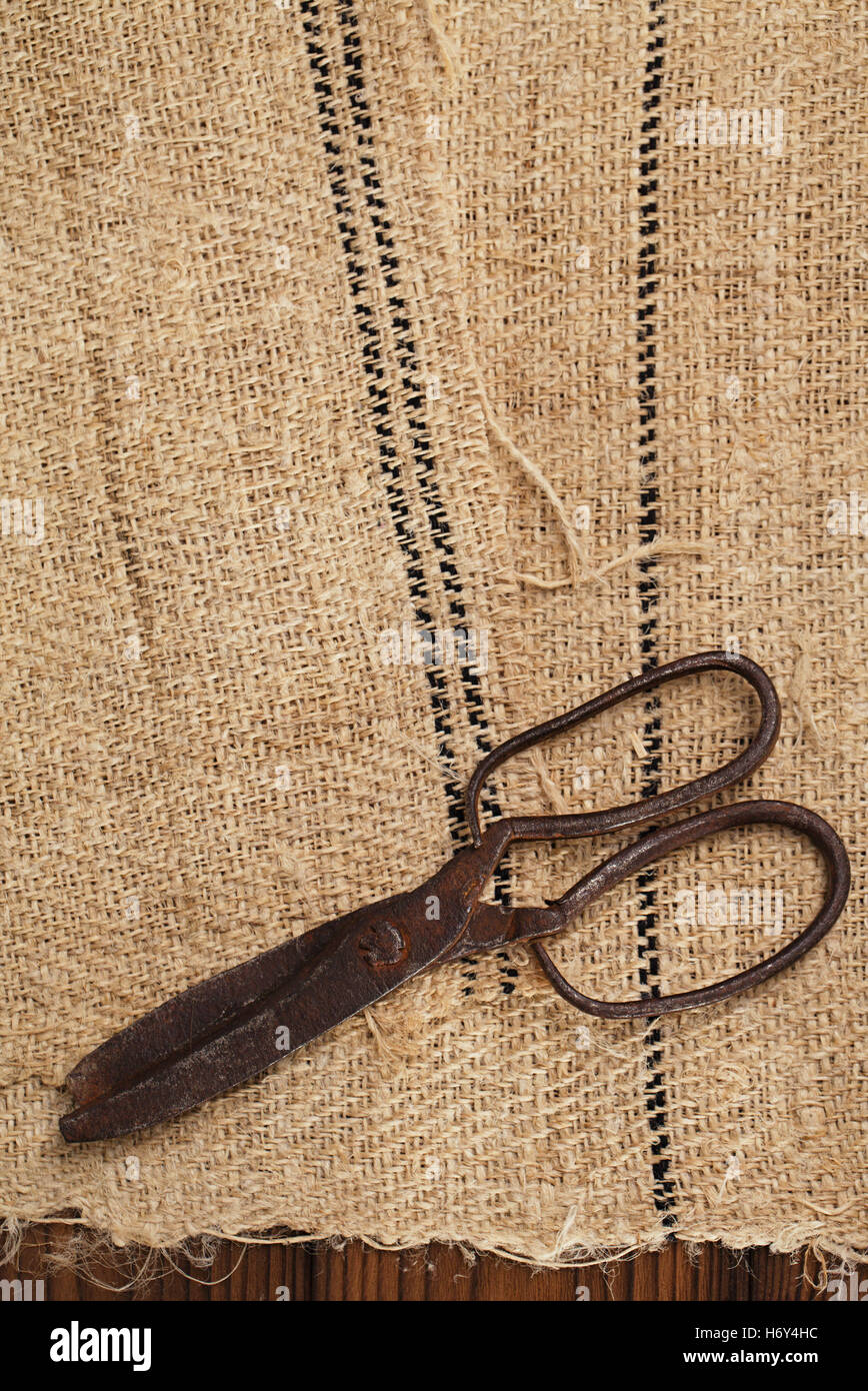 really antique iron scissors with spools on old grain sacking linen ...