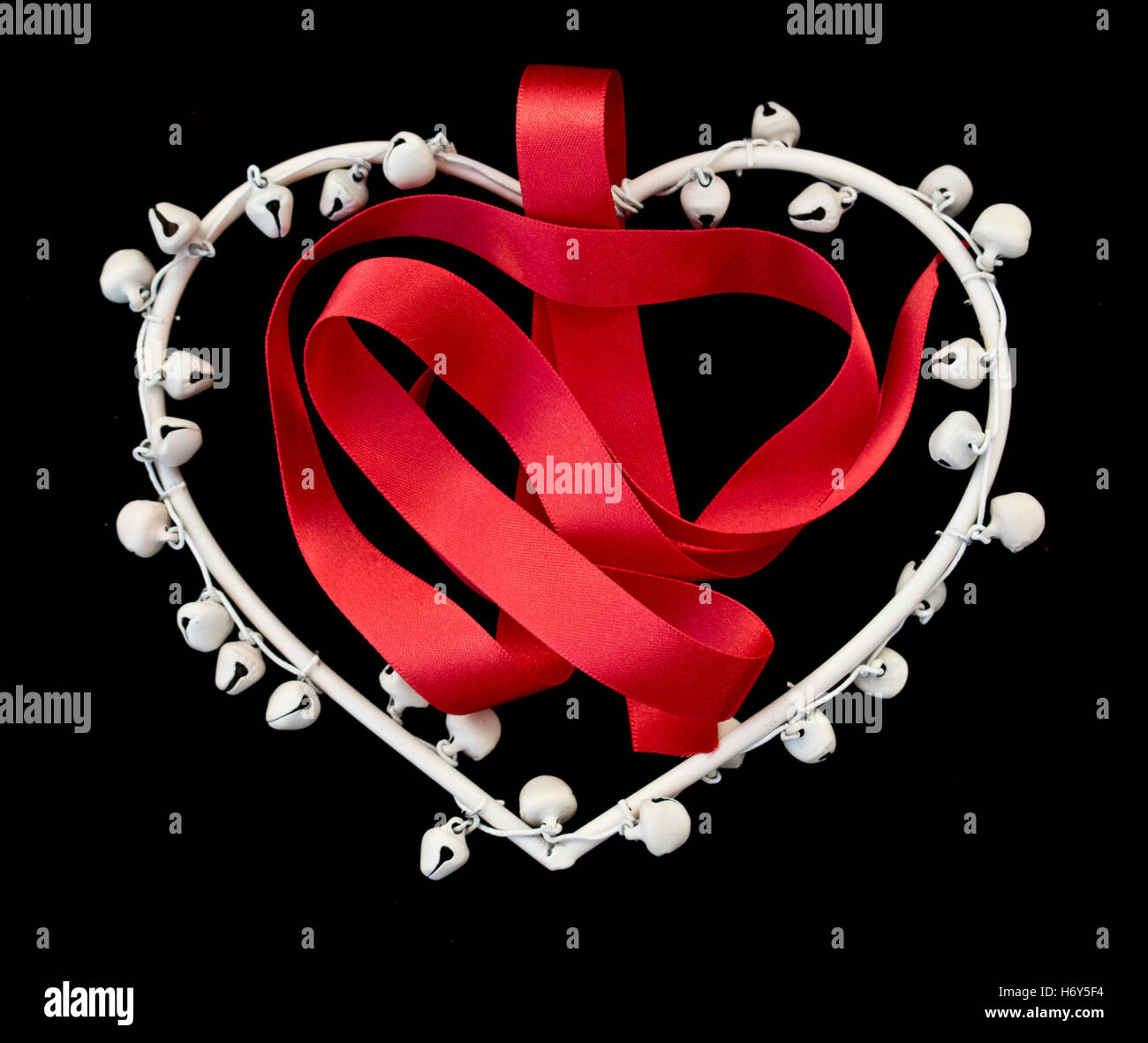 Heart Shape Metal Heart with Bells and Red Ribbon Stock Photo - Alamy