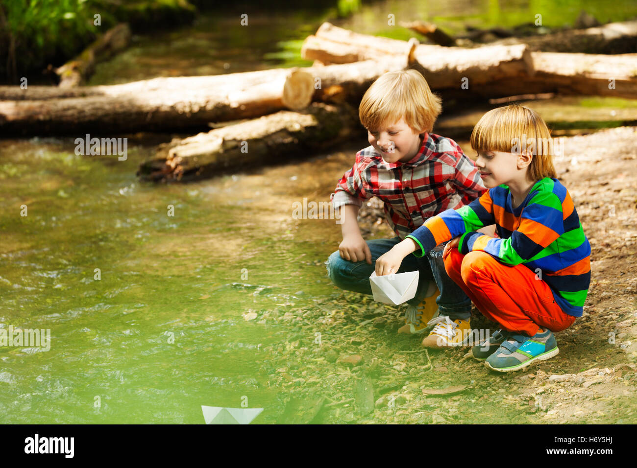 Kids playing paper boats hi-res stock photography and images - Alamy