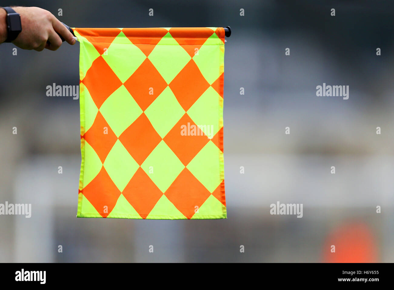 A linesman holds the flag up Stock Photo - Alamy