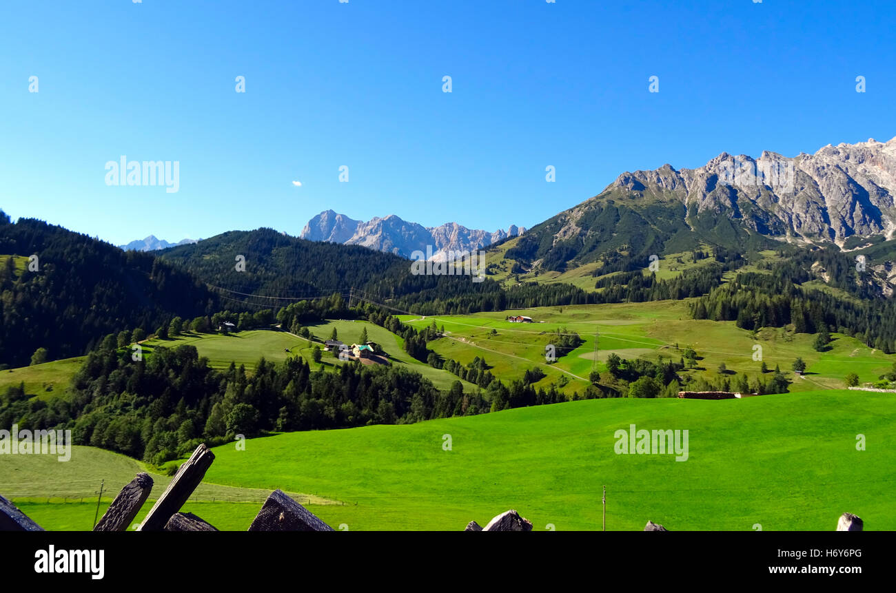 Beautiful alpine summer landscape. Mountains and sun, blue sky, calm ...